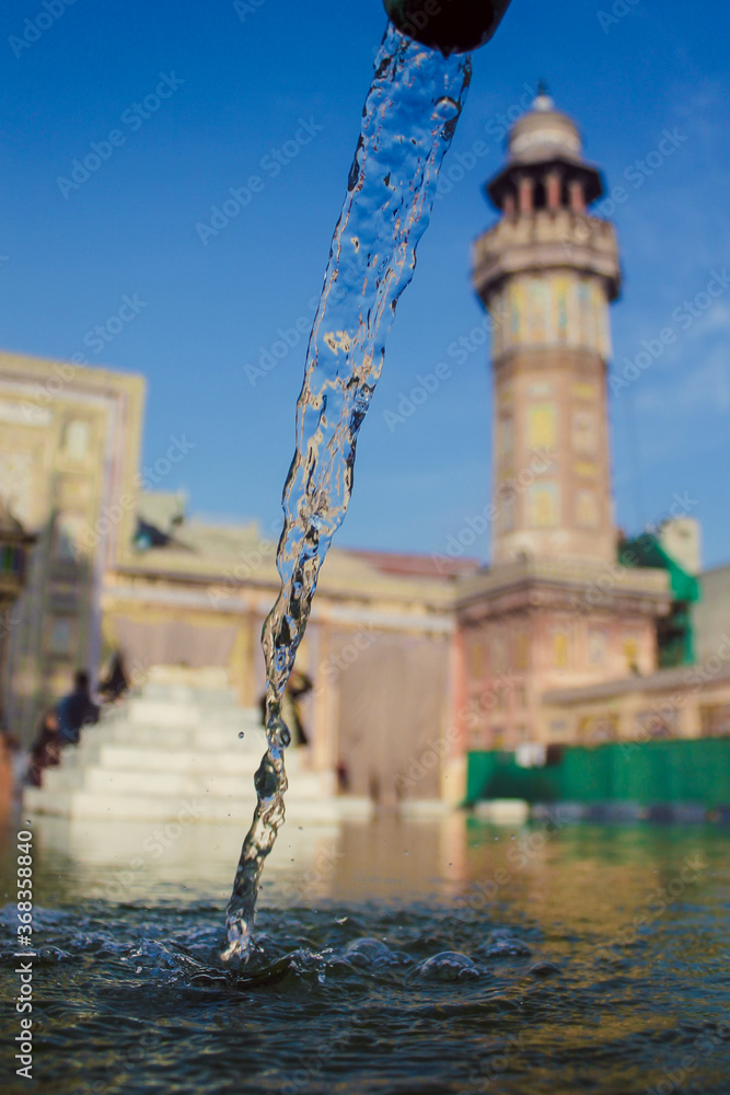 Water flowing in the courtyard of Masjid Wazir Khan for worshippers to ...