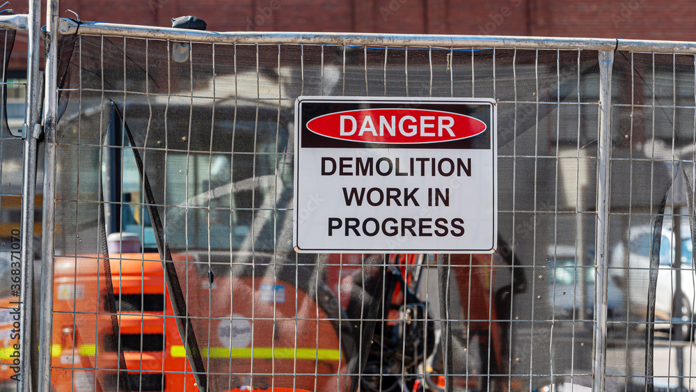 Danger, demolition work in progress sign in a real construction site ...