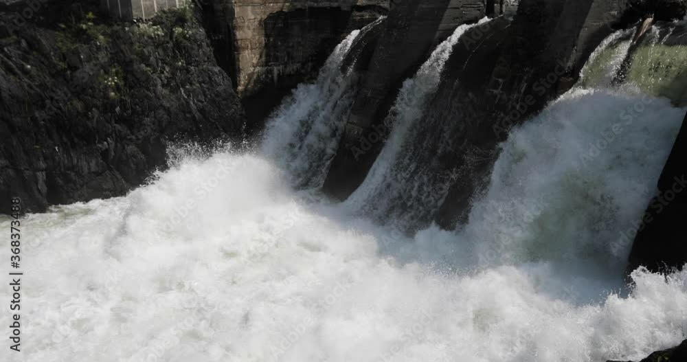 Abandoned hydroelectric power station on river, waterfalls with ...