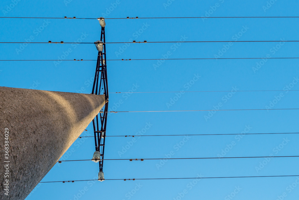 Concrete round electric pole with transverse metal diamond-shaped ...