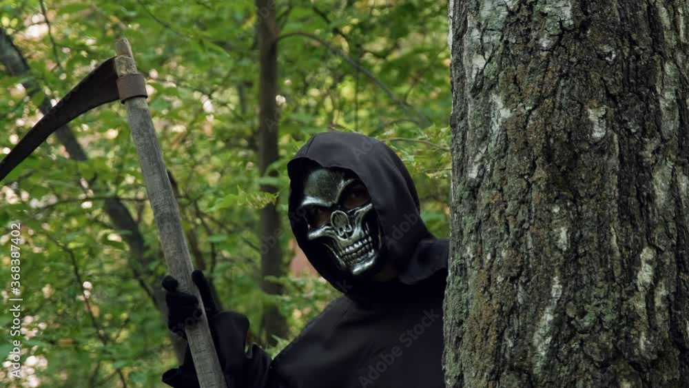 Grim Reaper with Scythe Peeps Out from a Tree in Summer Day. Life and ...
