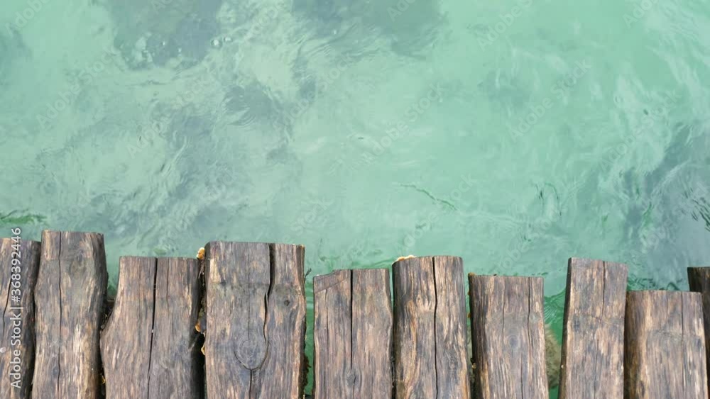 Top view of wooden pontoon over floating water in nature park Plitvice ...