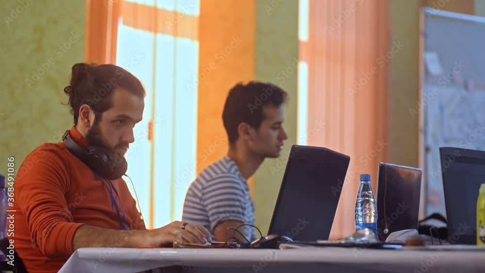 focused man employees working in coworking office. irrl design ...