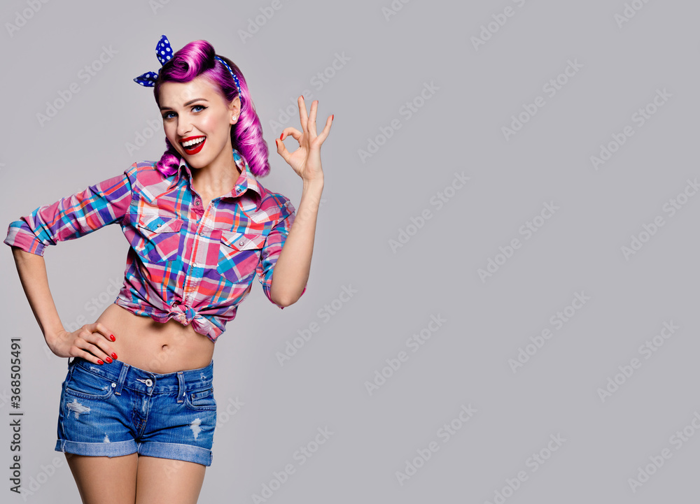 Pin up girl. Portrait photo of excited happy smiling woman showing ok ...