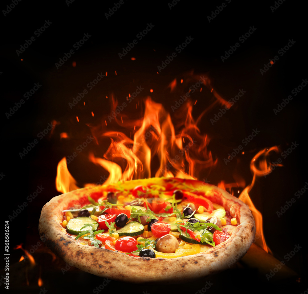 Hot tasty pizza with fire flames on dark background. Image for menu or ...