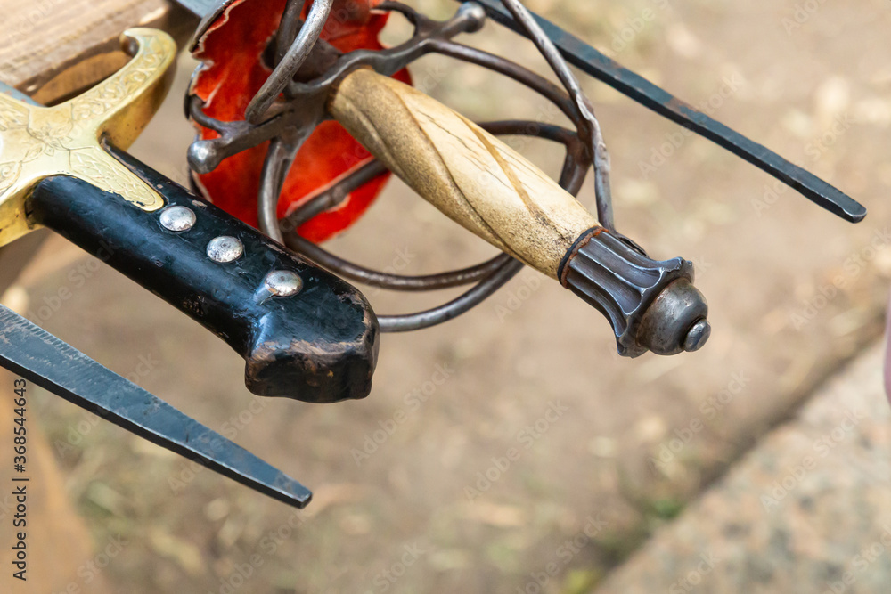 sharp weapon of the sword of a medieval warrior and a hilt of a rapier ...