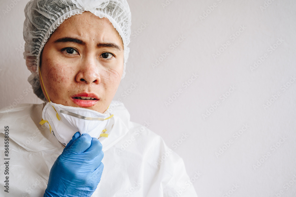 Healthcare worker with acne and facial wounds occur from a medical mask ...