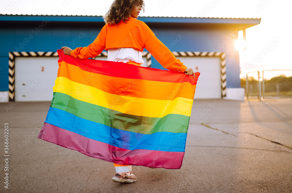 Beautiful African American lesbian girl with LGBT rainbow flag at ...