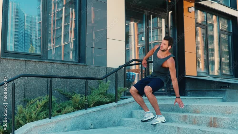 Young man exercising outside. Slow motion of man run or jog on street ...