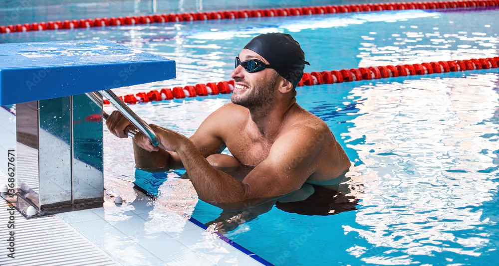 Professional swimmer getting ready to swim in the swimming pool near ...
