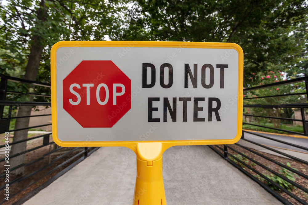 STOP Do Not Enter warning sign on a sidewalk ramp with railings Stock ...