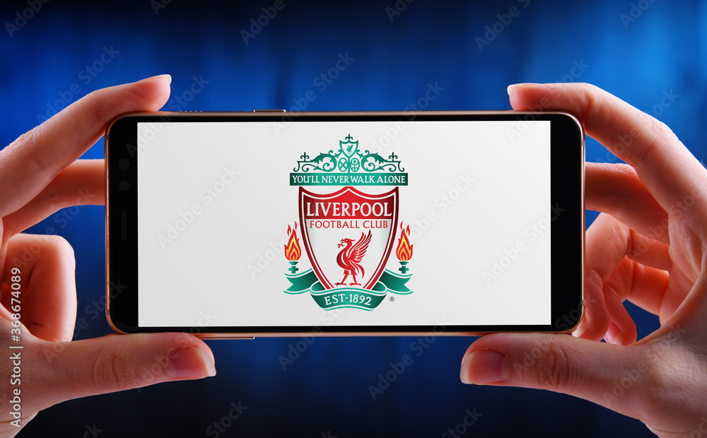 Hand holding smartphone displaying logo of Liverpool FC Stock Photo ...