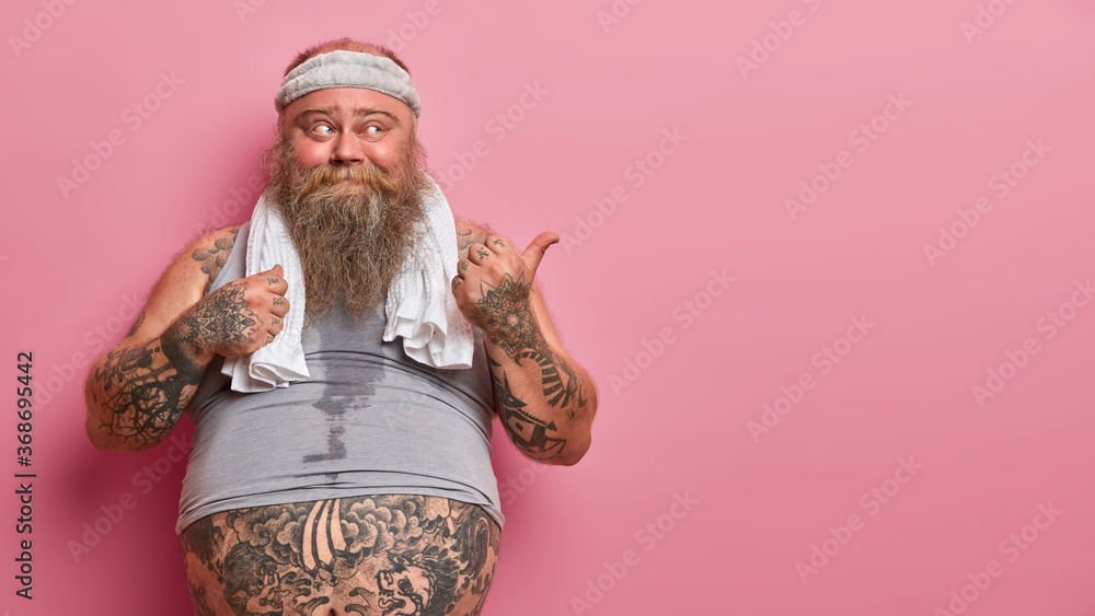 Purposeful persistent motivated stout guy has regular workout at gym ...