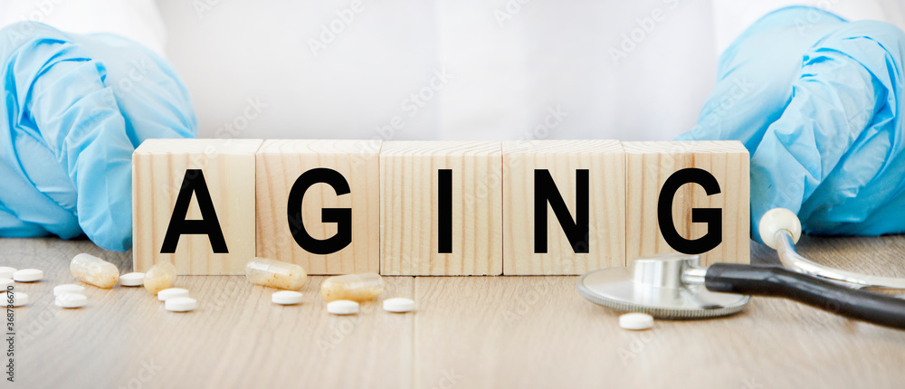 Ageing - word from wooden blocks with letters, growing old senescence ...