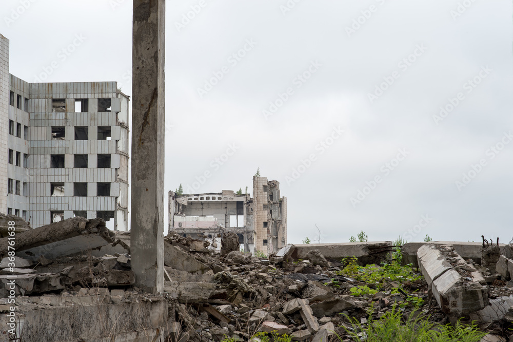 Destroyed large building with a pile of concrete debris and beams ...
