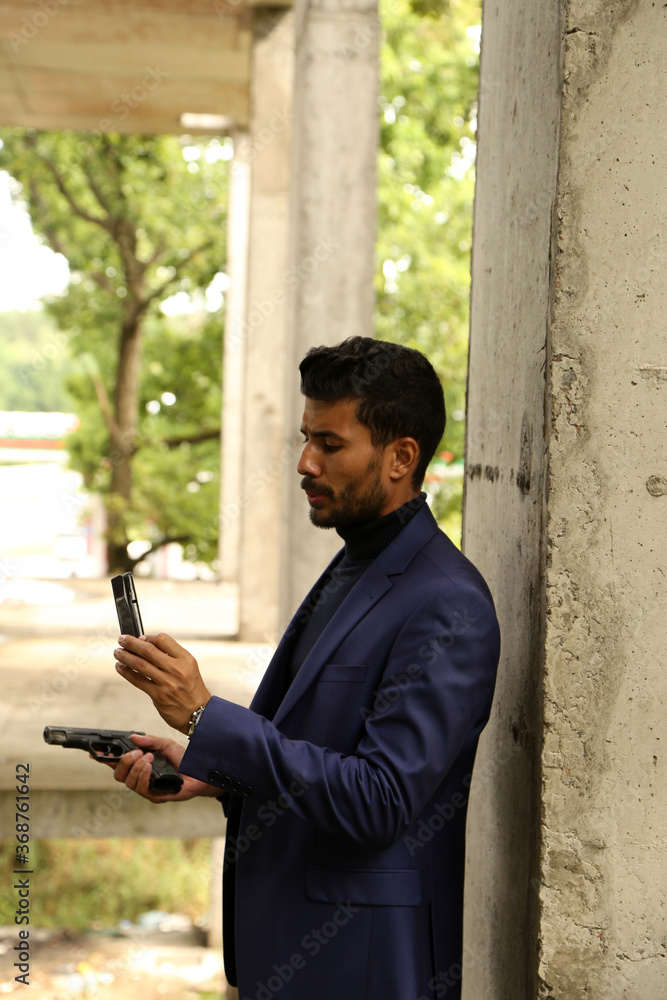 detective in a suit loading a gun Stock Photo | Adobe Stock