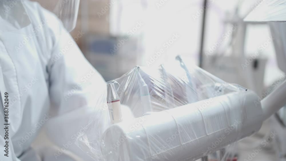 Process of hygienic preparation of dental clinic tools. Staff wearing ...