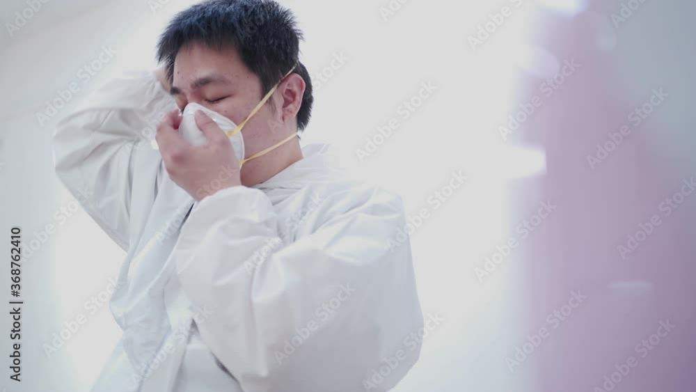 Asian man suit up protective work wear, male put on ppe suit, personal ...