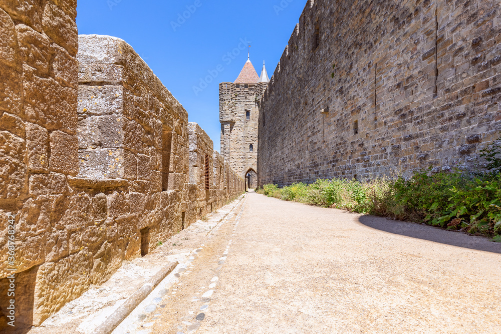 Wide fortified walls with walkways and arches of medieval castle of ...