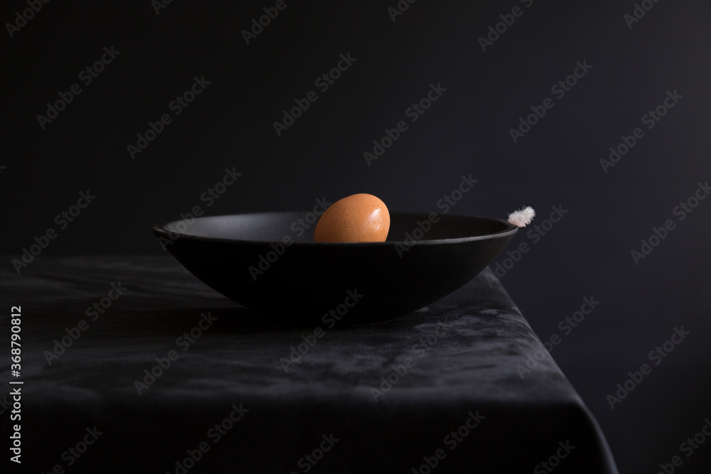 Natural light fine art photography still life of a single egg in black ...