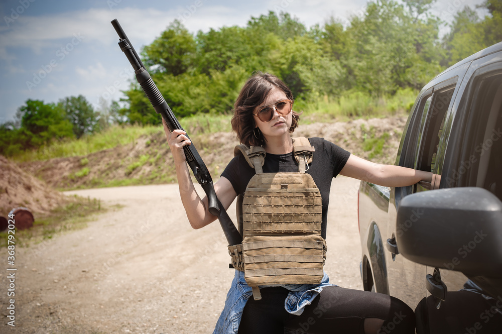 Beautiful and attractive female military soldier with shotgun pump gun ...