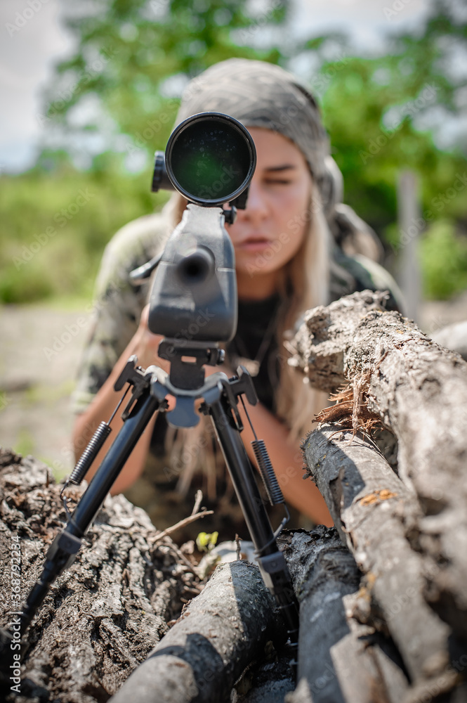 Female soldier shooting with sniper rifle. Woman with weapon. Firearm ...
