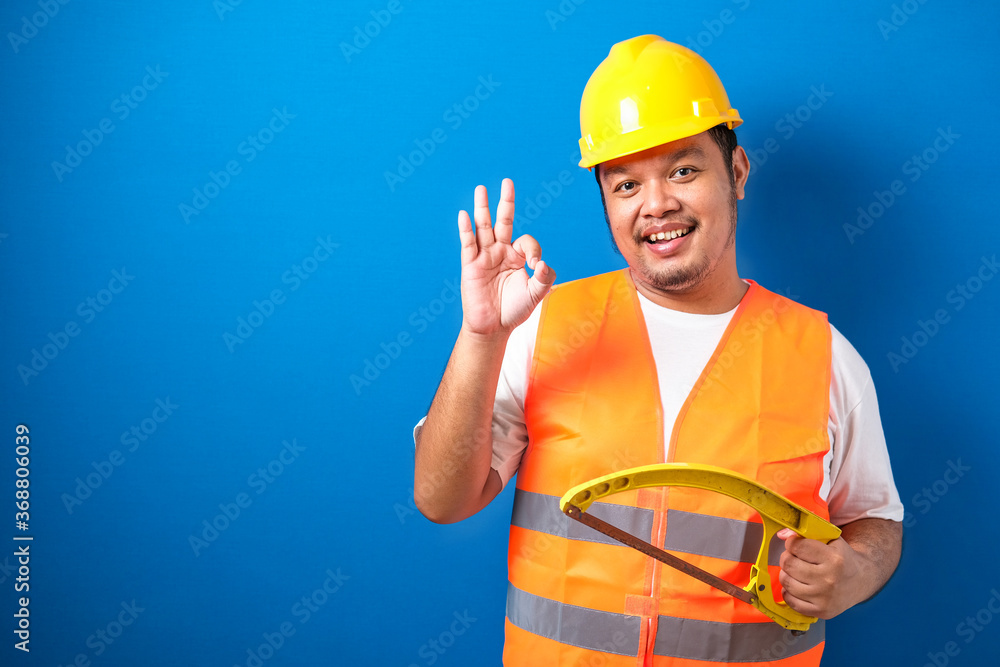 Fat asian construction worker wearing orange safety vest and helmet ...