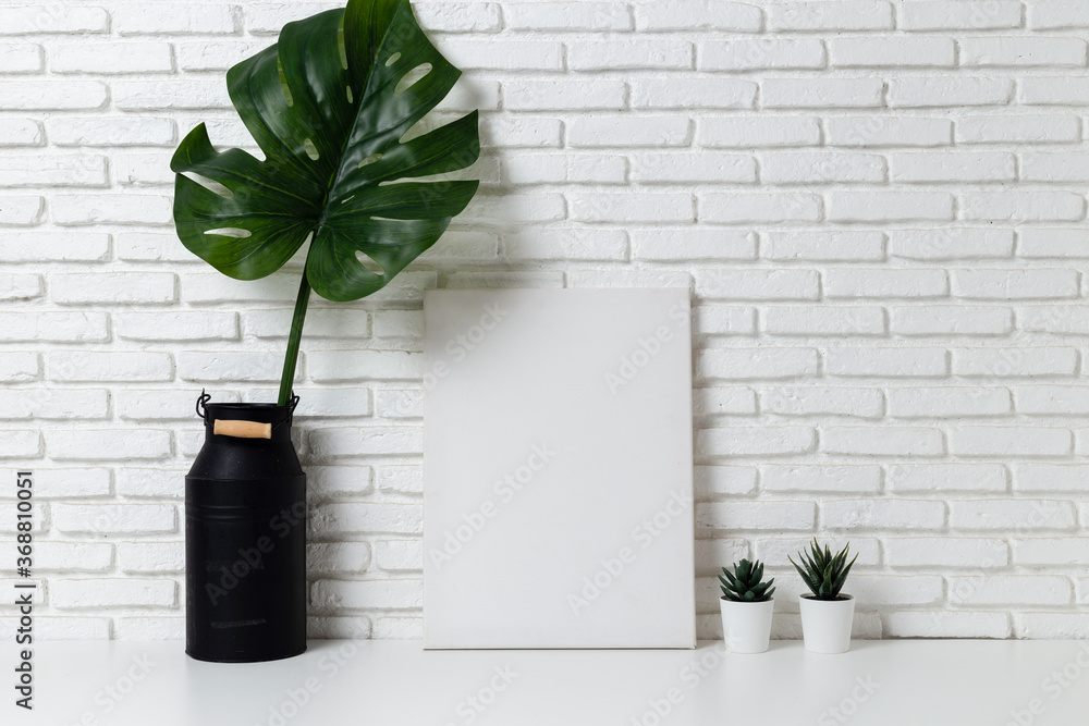 Mock up Empty white canvas frame on desk Stock Photo | Adobe Stock