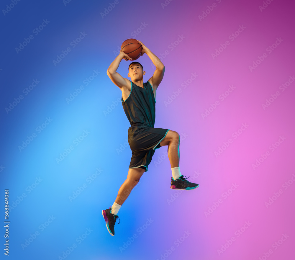 Winner. Young basketball player in action, motion in high jump on ...