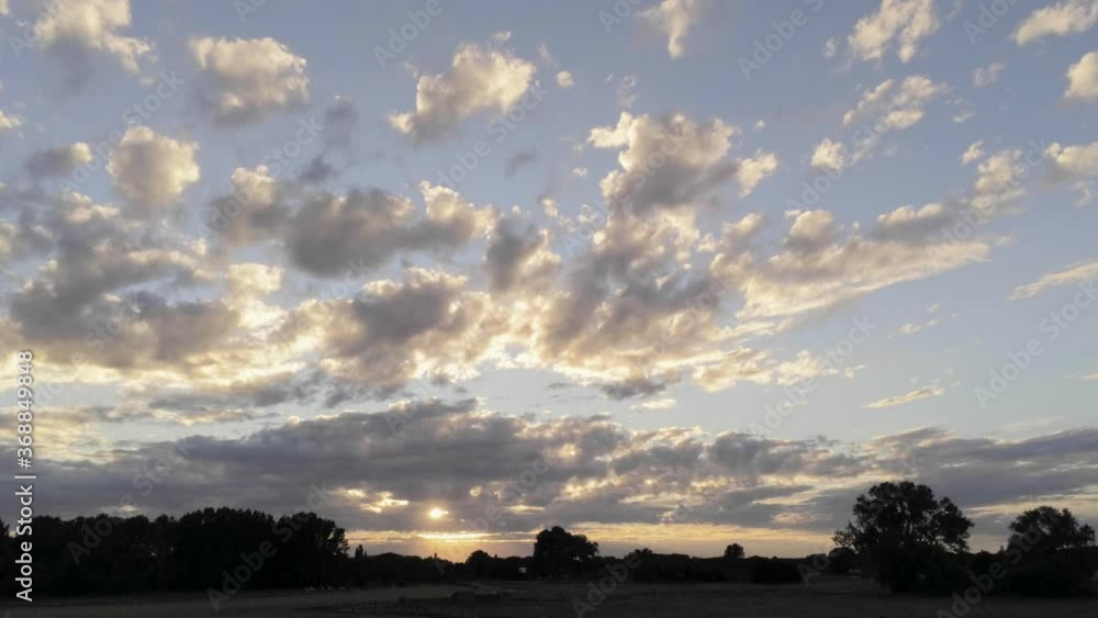 Duality of sunset landscape with dark lighted meadows and cornfields in ...