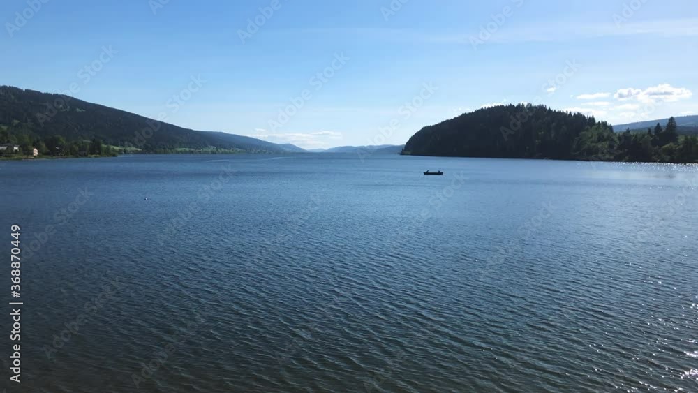 Scenic view of the Joux lake from Le Lieu, with a small pleasure boat ...