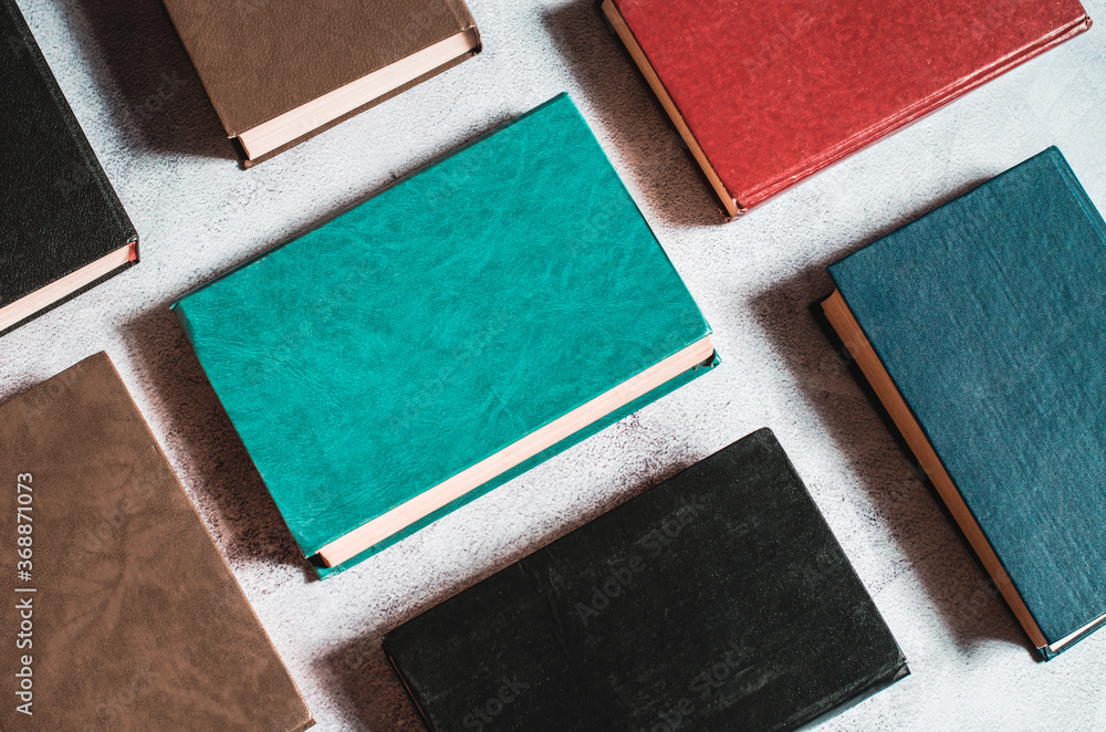 Books next to each other top view. Background from multicolored old ...