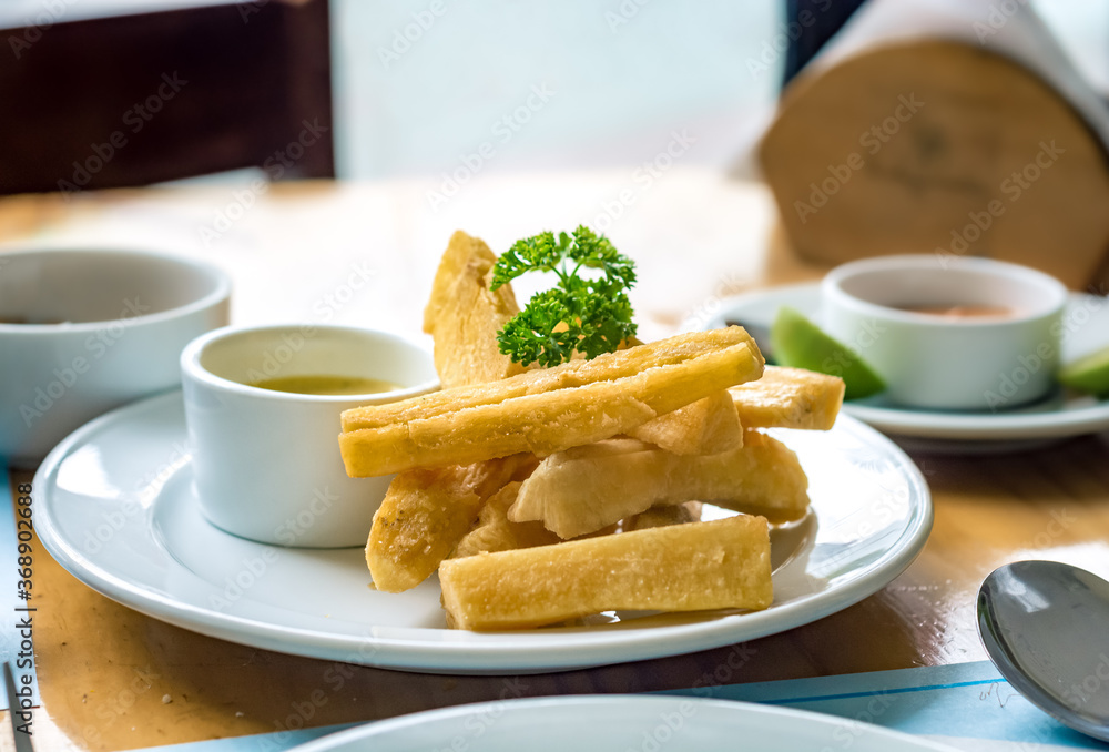 Deep fried cassava (yuca frita) with cilantro and different dips Stock ...