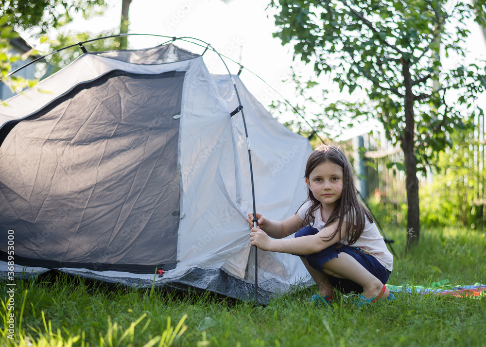 little girl with a tent in nature. Camping and outdoor recreation Stock ...
