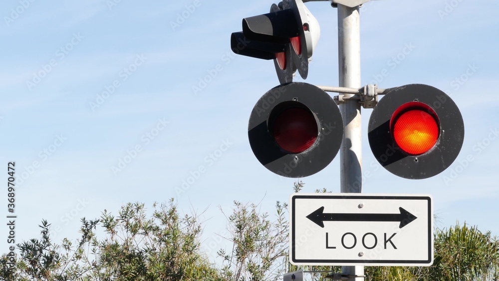 Level crossing warning signal in USA. Crossbuck notice and red traffic ...