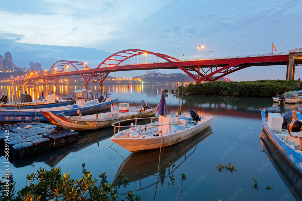 Early morning scenery of boats parking by riverside and in the ...