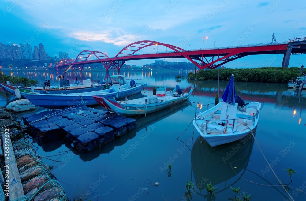 Early morning scenery of boats parking by riverside and in the ...