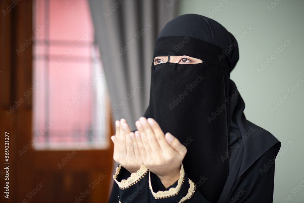 young modern middle eastern muslim woman with islamic prayer hand; concept of Ramadan, Eid al ...