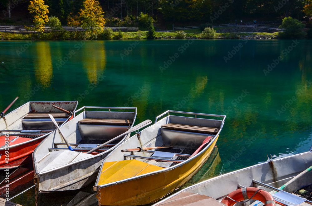Colorful empty rowing boats on the lakes called Laghi di Fusine ...