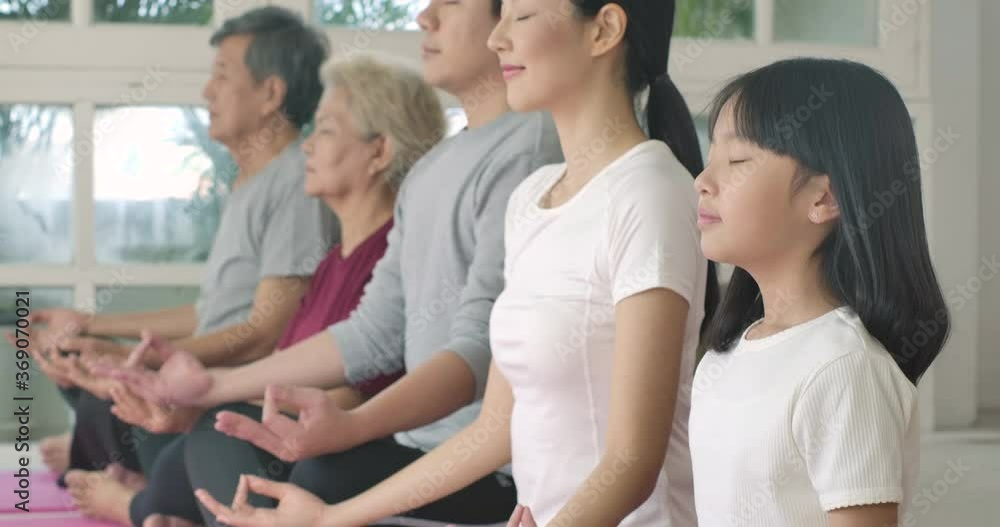Group of asian family practicing yoga exercise lesson at home. Happy ...