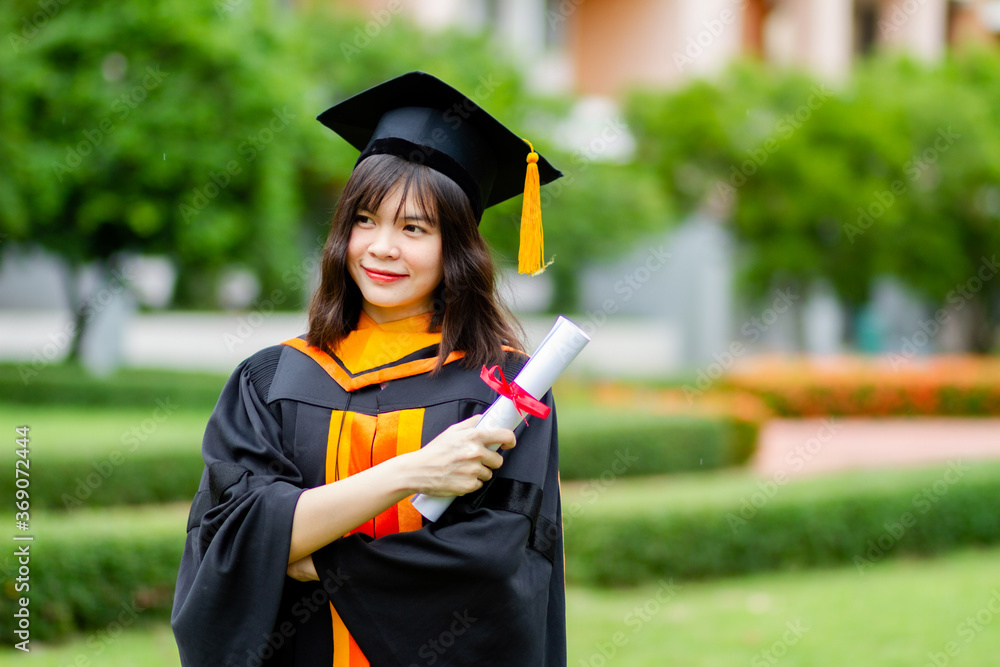Graduation girl raises her hand to celebrate her graduation, complete ...