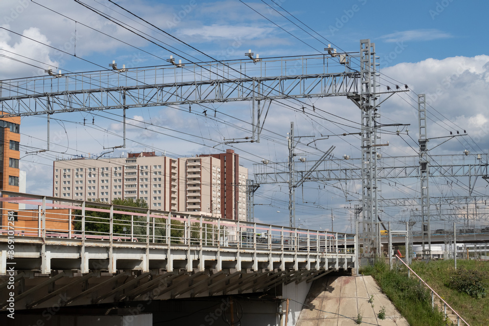 Electrified railway on the background of a residential building, wires ...