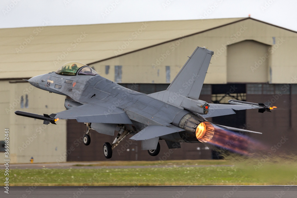 Advanced military fighter jet aircraft taking off with full afterburner ...