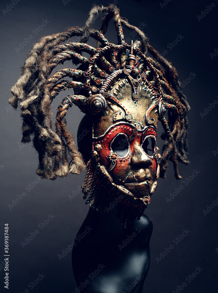 Creative african mask, dark studio background Stock Photo | Adobe Stock