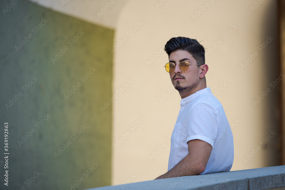 Young styled arabic man with black hair and goatee in white shirt and ...