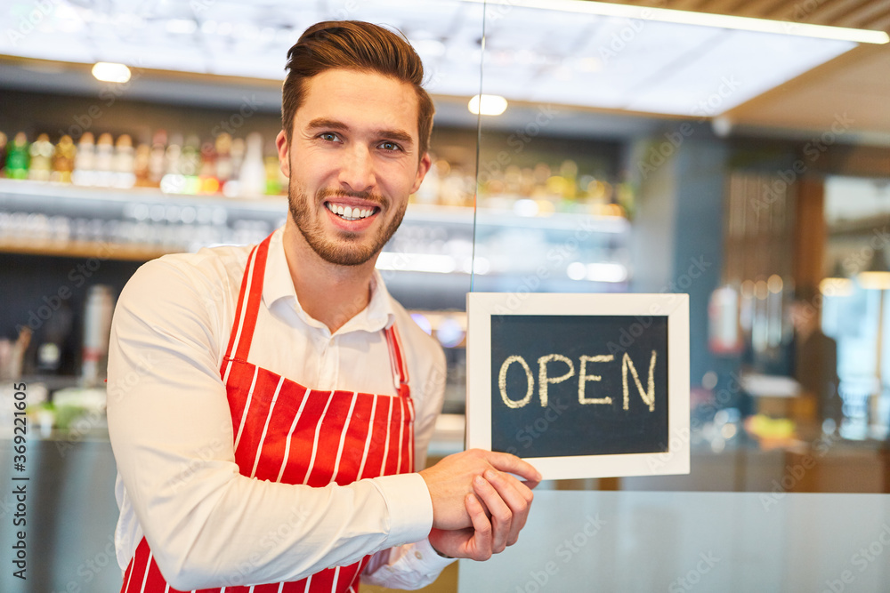 Restaurant founder holds an open chalkboard Stock Photo | Adobe Stock