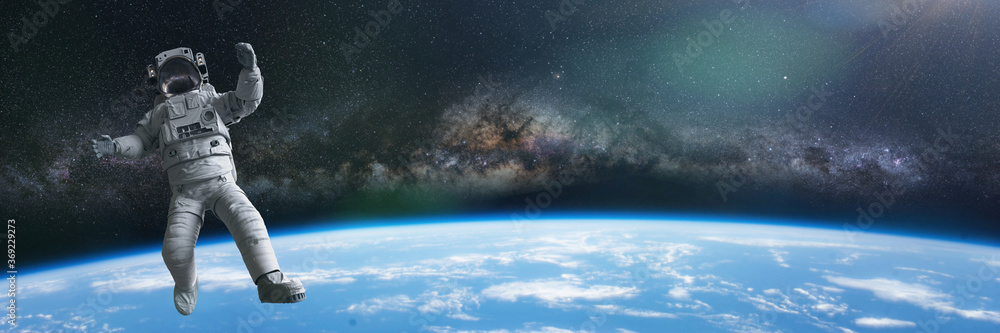 astronaut during a spacewalk in orbit of planet Earth, background ...