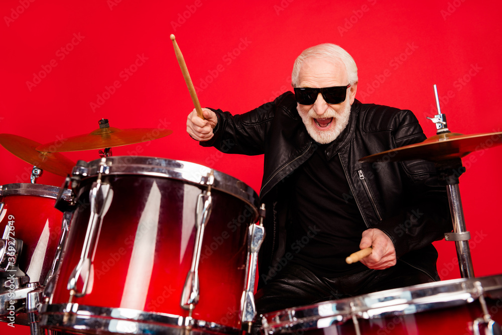 Portrait of crazy funky old man punk rocker play drum enjoy night club ...