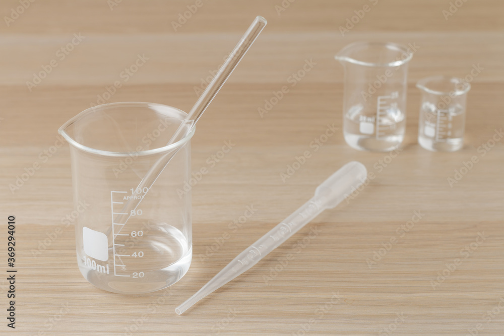 100 ml transparent measuring glass beaker with a glass rod and plastic ...