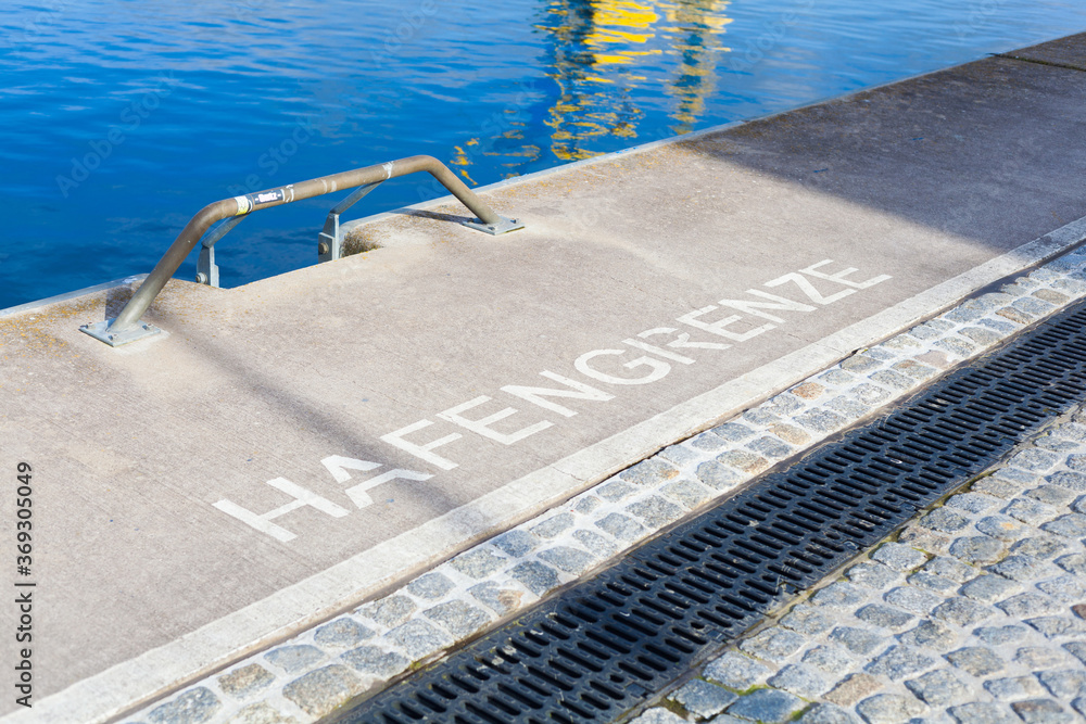 Harbor edge with lettering: "Harbor border" on the ground with white ...